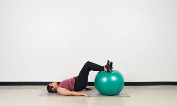 How can I work out my hamstrings using a stability ball at home? - FITPAA